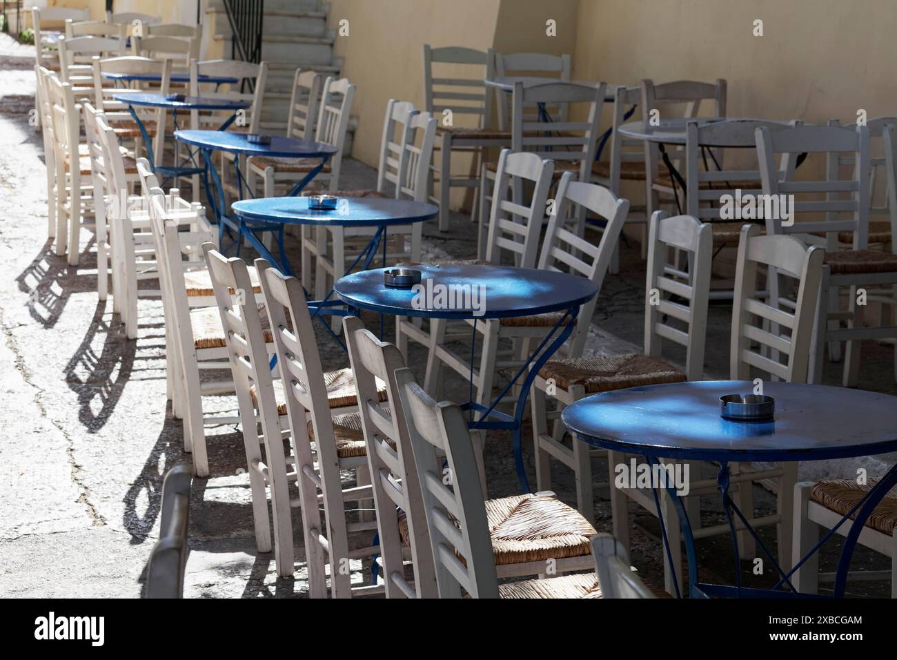Row of blue tables and white chairs, taverna in the historic centre of ...