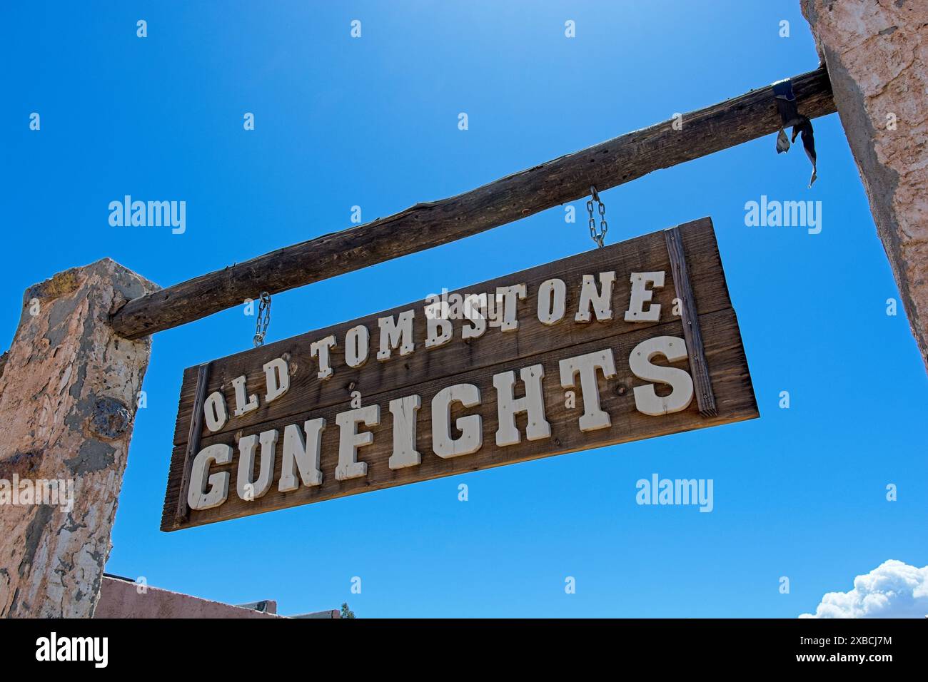 Wooden Old Tombstone gunfight sign under bright blue sky Stock Photo ...