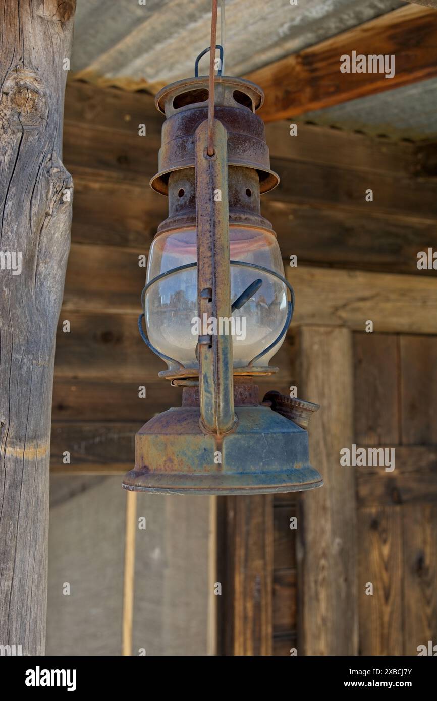 Rusty miners lamp hanging from rafter on rustic wood portico Stock ...