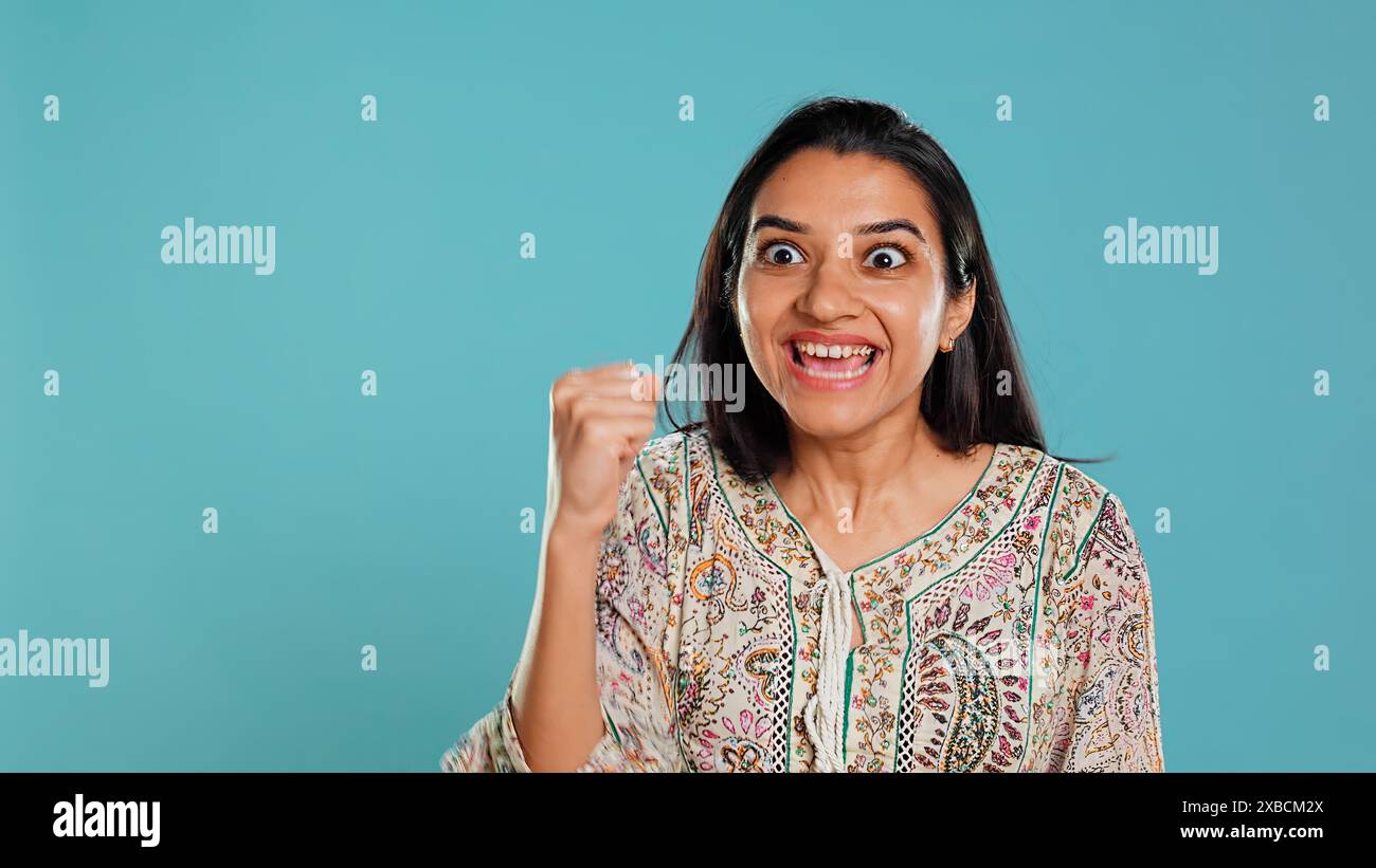 Portrait of joyful indian woman celebrating, showing positive emotions ...