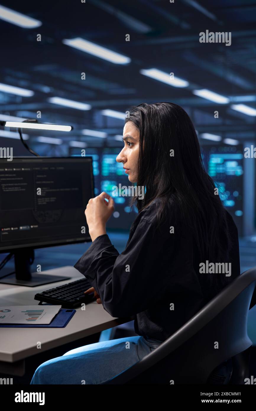 Worker checking for signs of imminent failure in data center ...