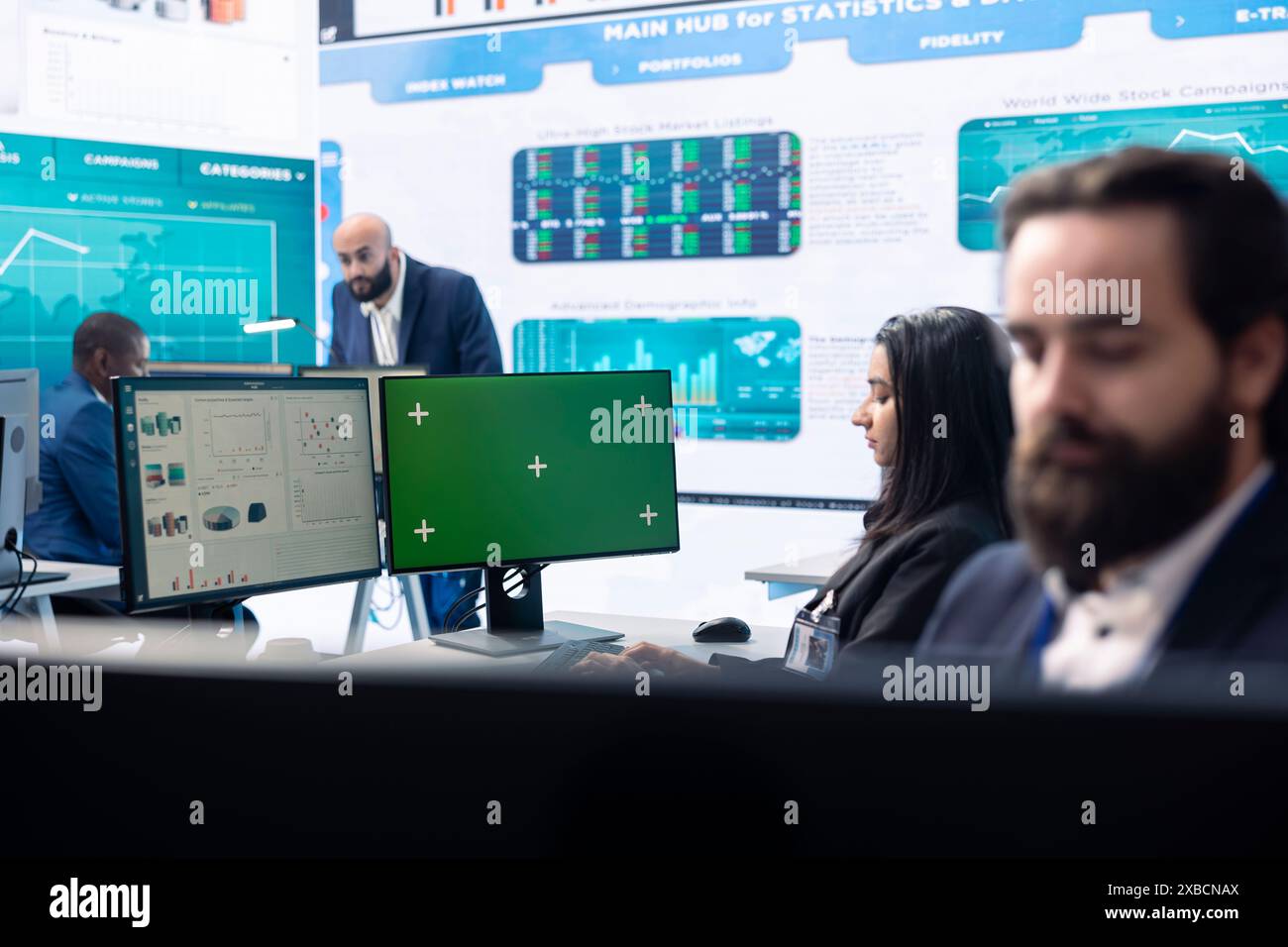 Businesswoman analyzing infographics next to green screen in enterprise ...