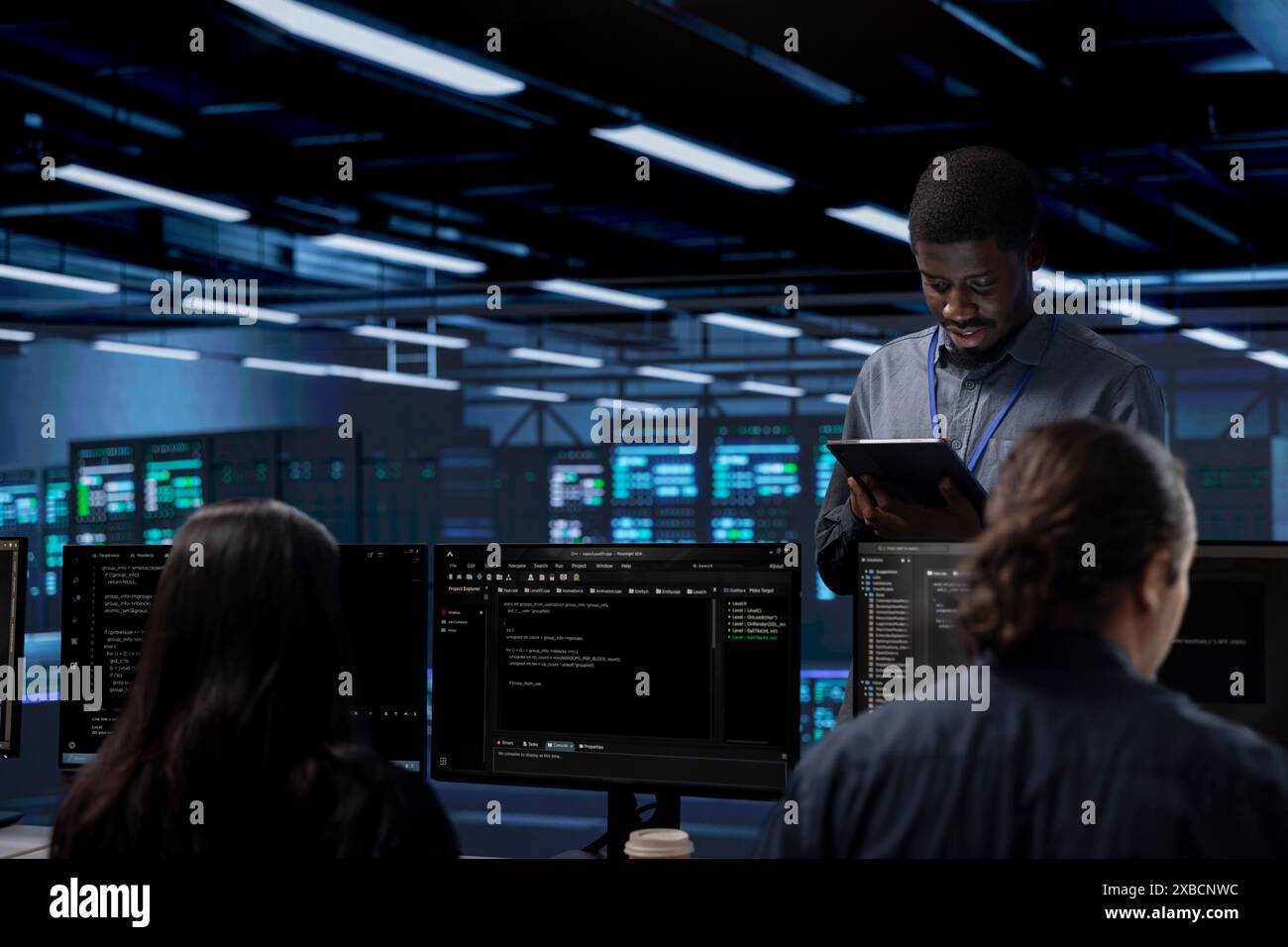 Multiethnic team in server room checking recovery plan and monitoring ...