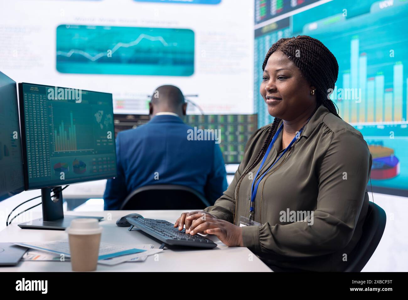 Chief executive officer reviews data shown on big display in the office ...