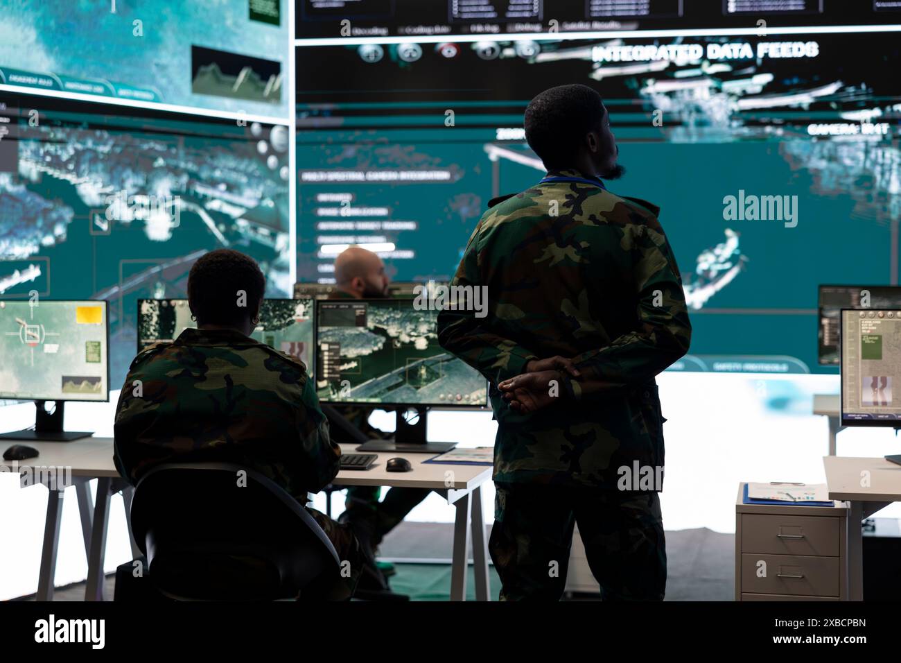 Army conscript examining crucial real time data on a big screen ... Army conscript examining crucial real time data on a big screen ...