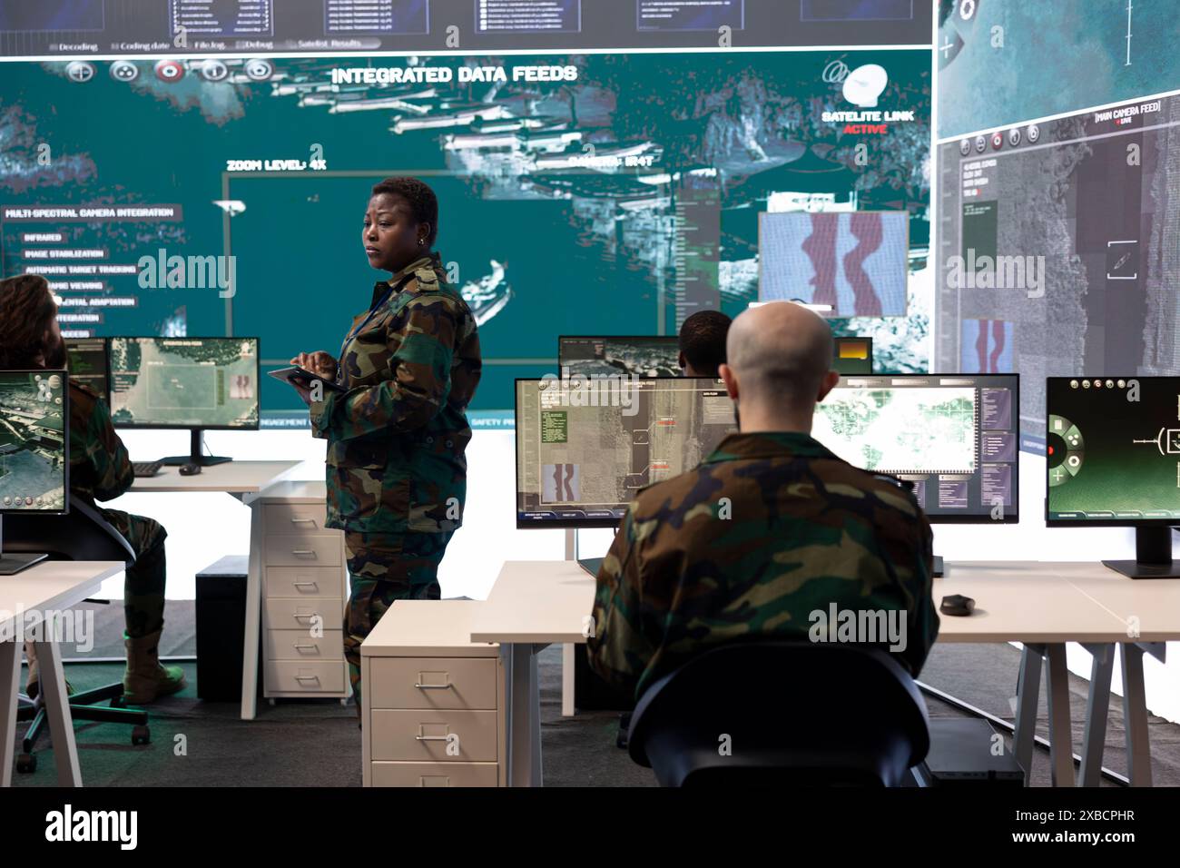 Female master sergeant gathers battlefield intelligence reports on a ...