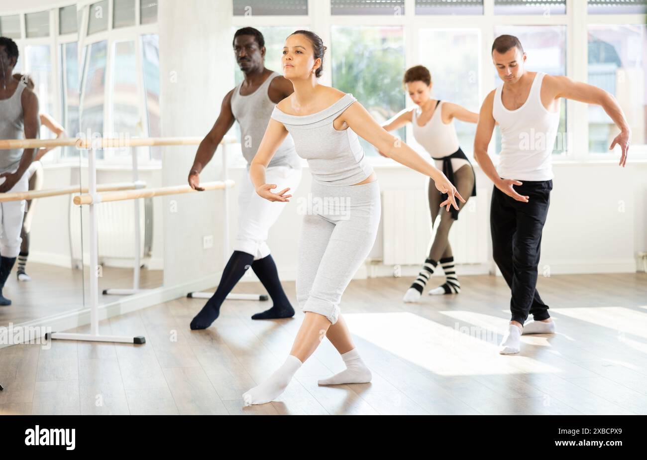 Asian female ballet dancer mastering moves at group rehearsal Stock ...