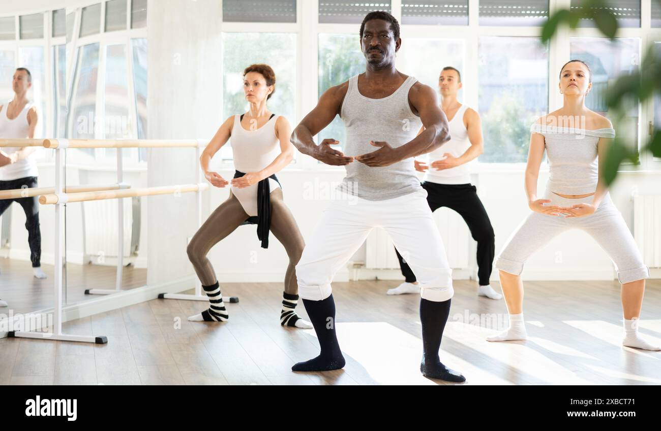 African American man practicing ballet movements in choreography studio ...