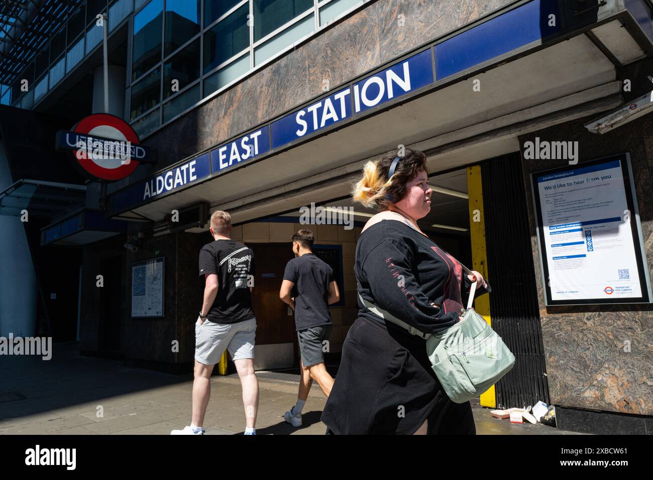 GV view of people making their way past Aldgate East tube station, East ...