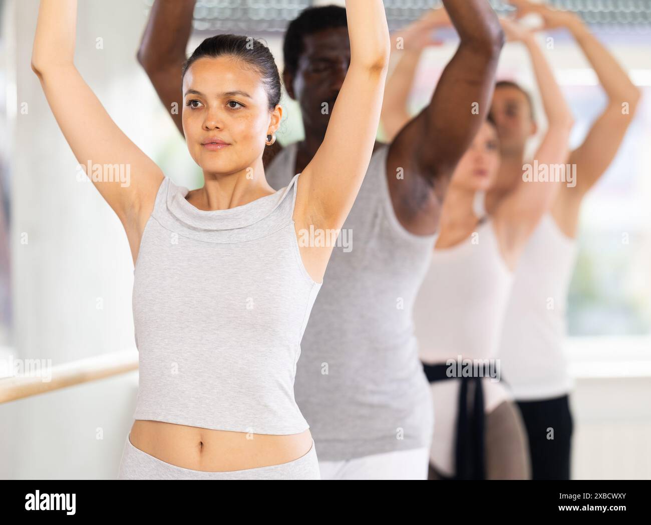 Group of dancers stand in fifth position at barre Stock Photo - Alamy