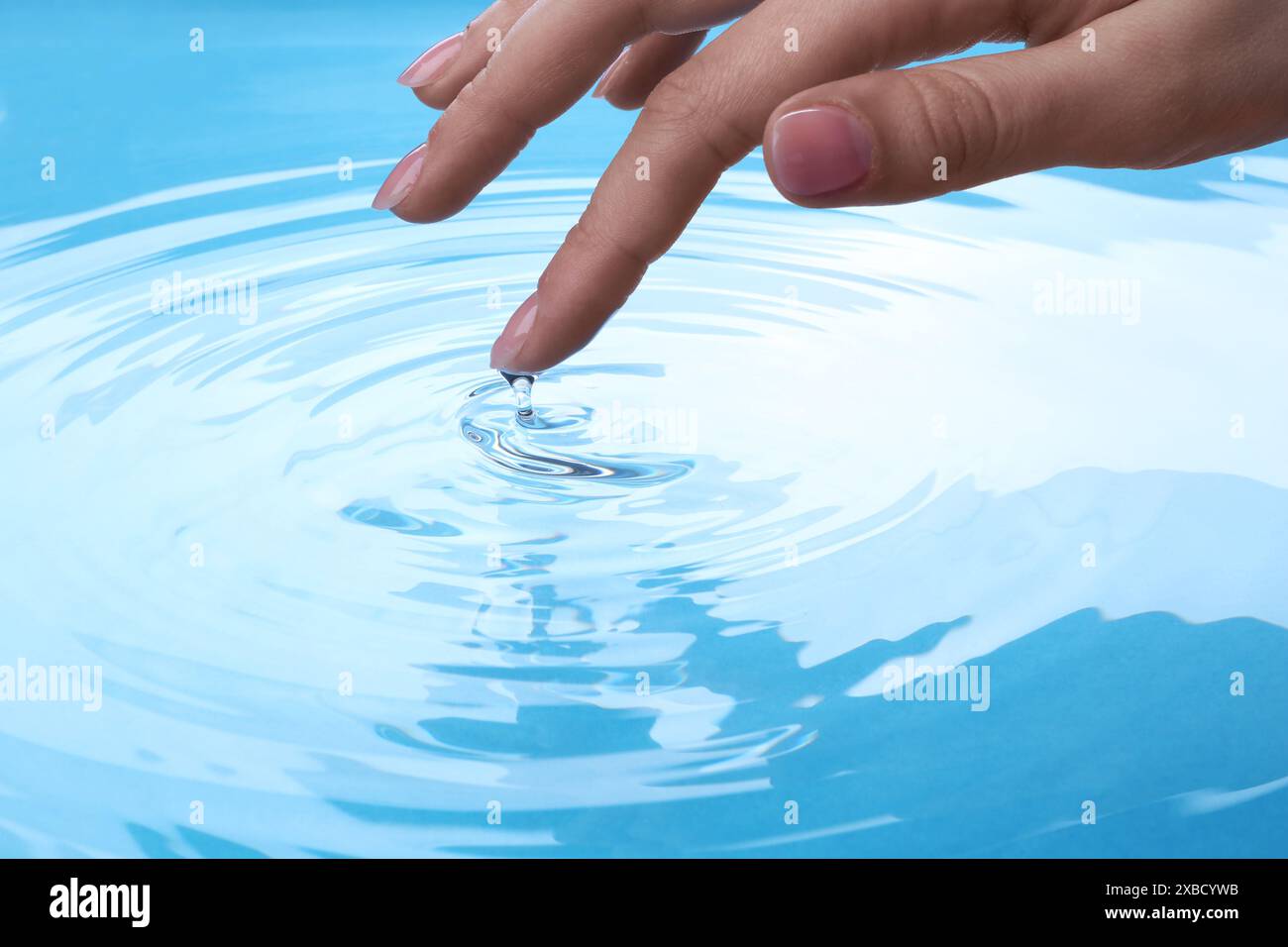 Woman touching clear water, closeup. Making ripples Stock Photo - Alamy