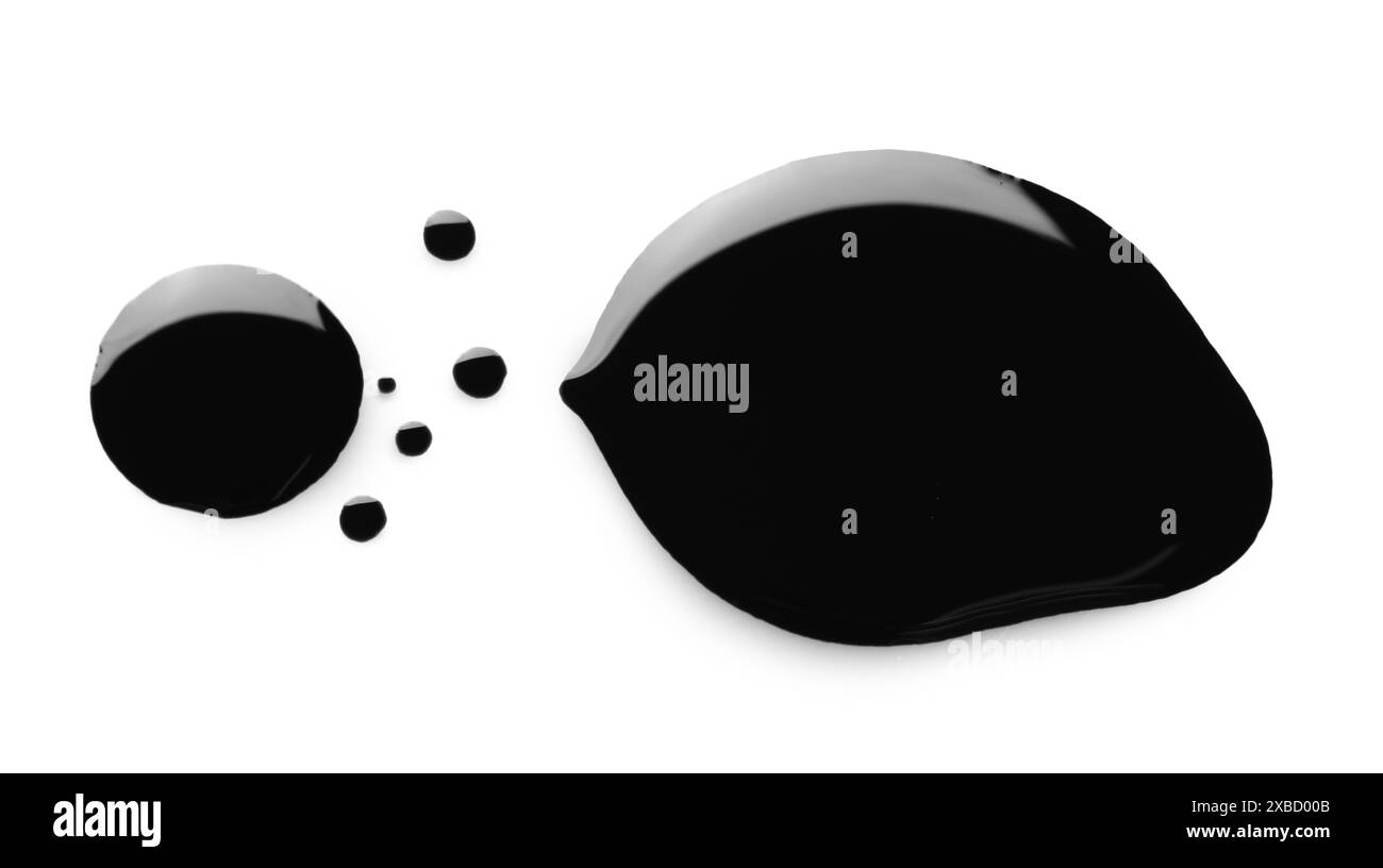 Blobs of black oil isolated on white, top view Stock Photo - Alamy