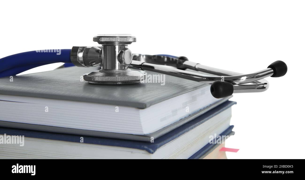 Stethoscope on stack of books against white background Stock Photo - Alamy