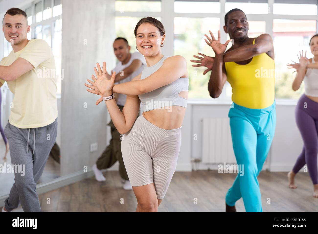 Group of multiethnic active people dancing social dance movements in ...