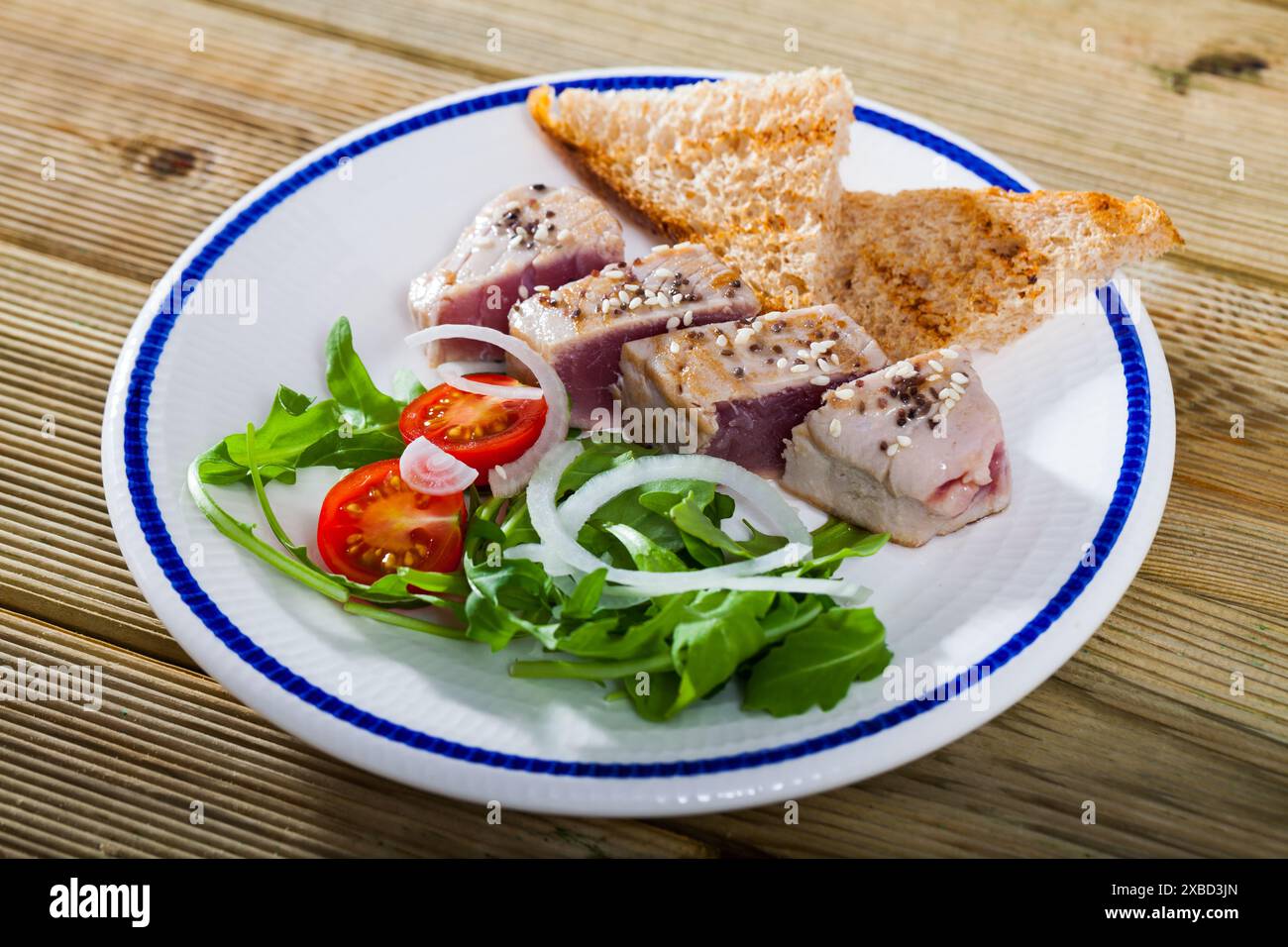 Deliciously lightly fried tuna with toasted bread, served with greens ...