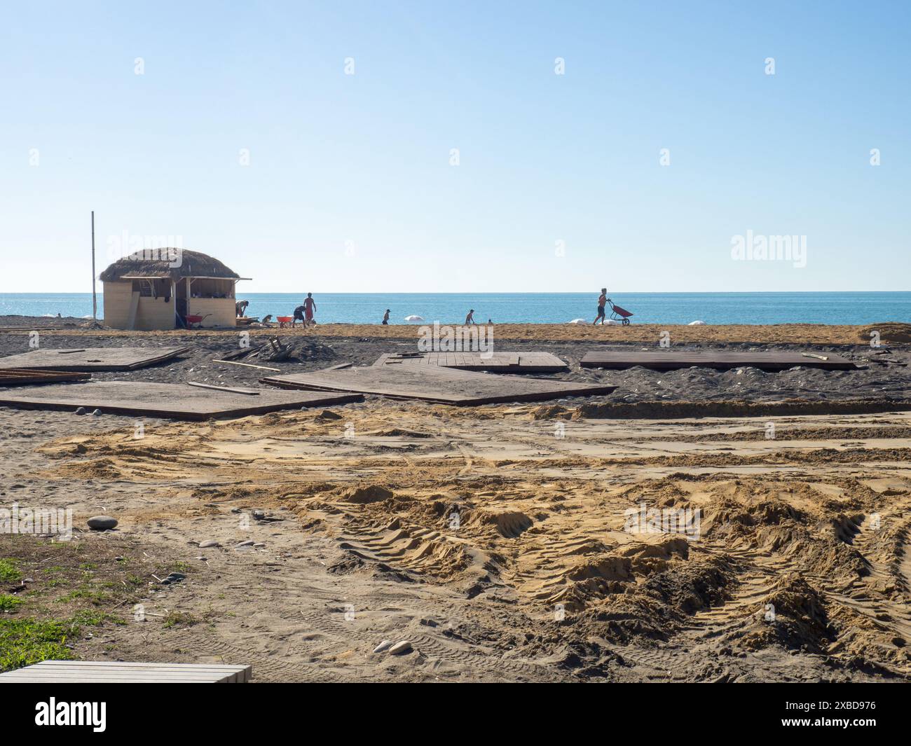 Batumi, Georgia. 04.06.2024 Excavation. Sand on the beach. Workers are ...