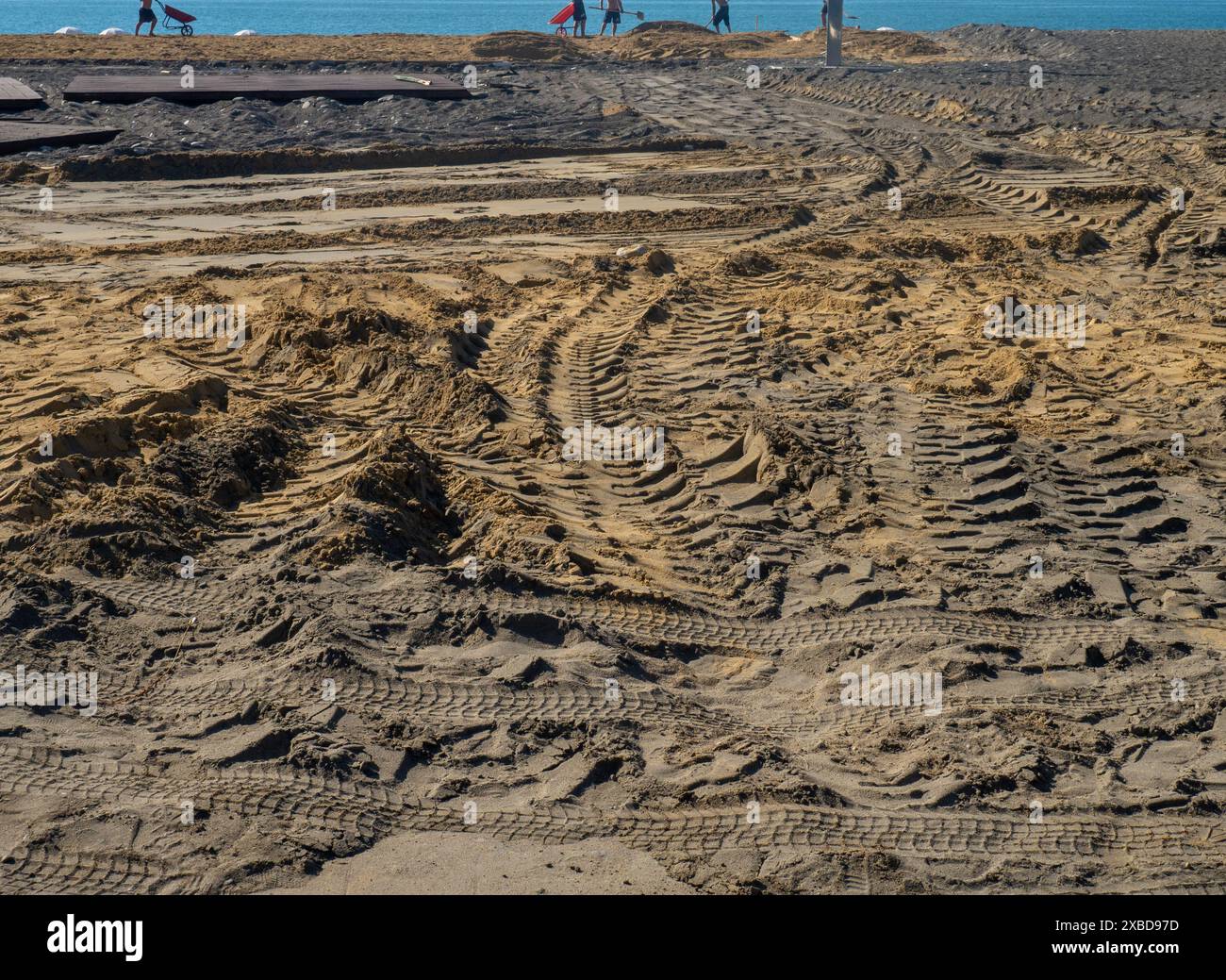 Excavation. Sand on the beach. Workers are digging. Resort place ...