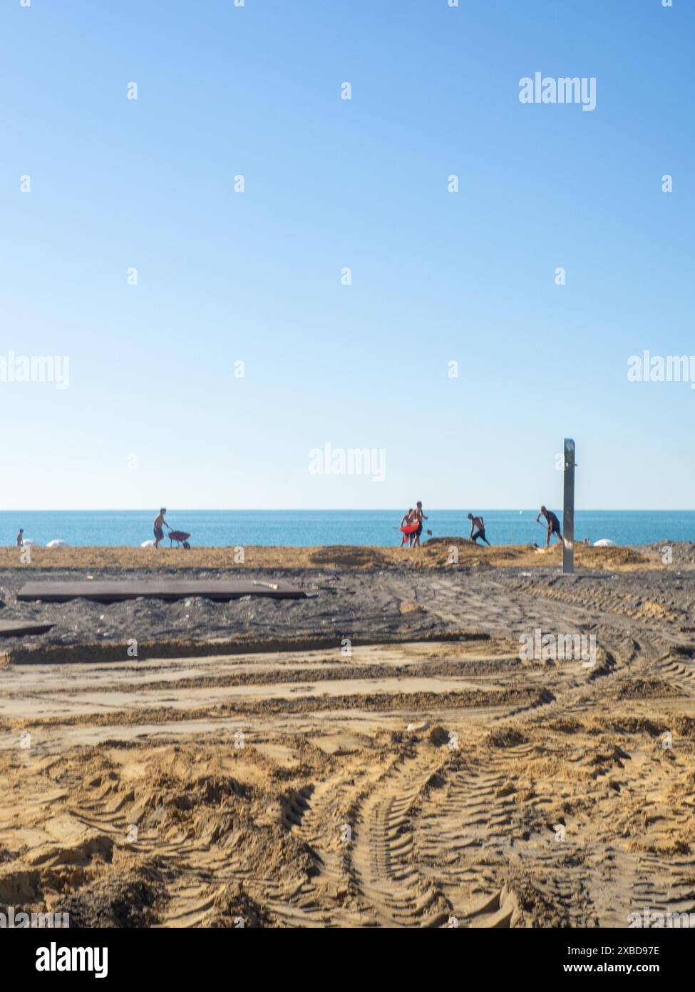 Batumi, Georgia. 04.06.2024 Excavation. Sand on the beach. Workers are ...