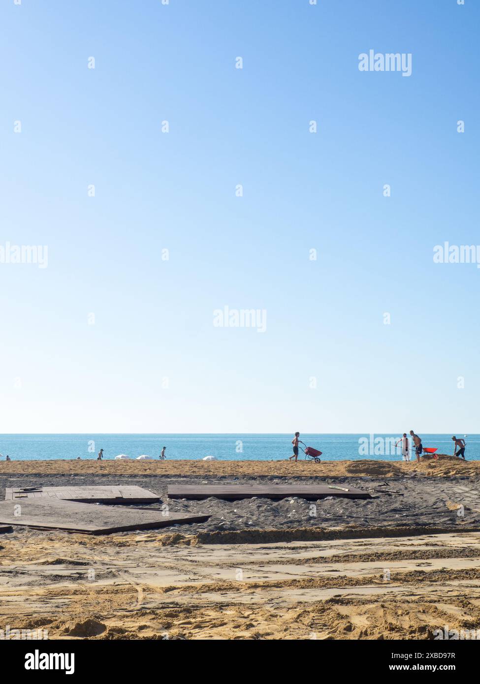 Batumi, Georgia. 04.06.2024 Excavation. Sand on the beach. Workers are ...