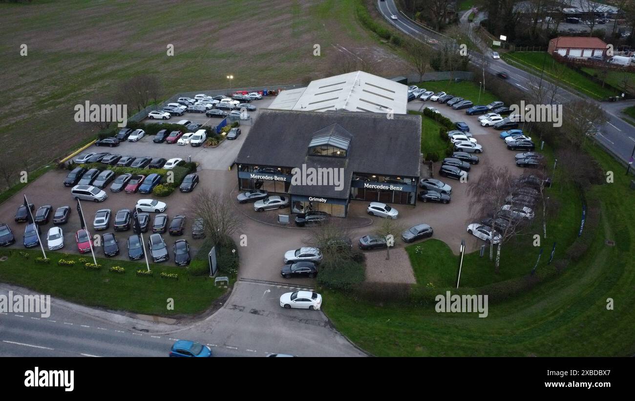 Cars parked by roadside in daytime at parking lot Stock Photo - Alamy