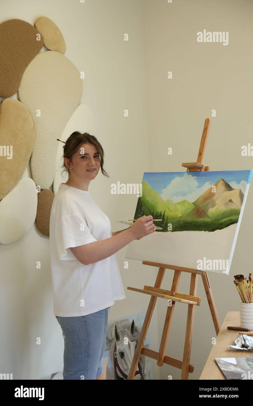 Woman drawing landscape with brush in studio Stock Photo - Alamy