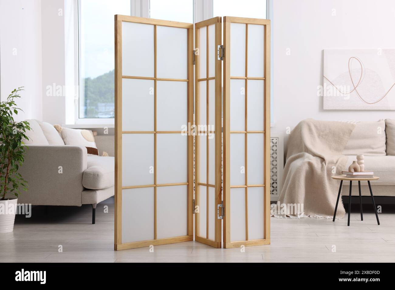 Folding screen, sofas and side table in living room Stock Photo - Alamy