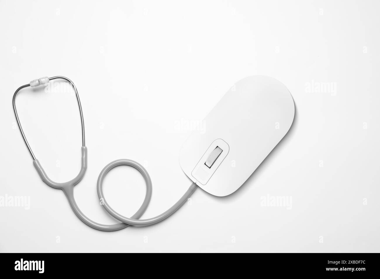 Stethoscope with computer mouse isolated on white, top view. Online ...