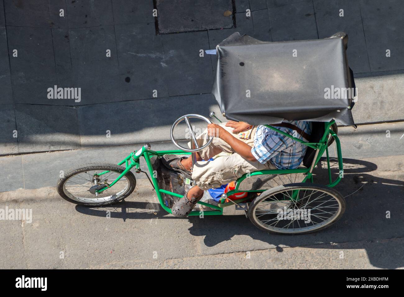 A man rides a tricycle for disabled people down the street, Saigon ...