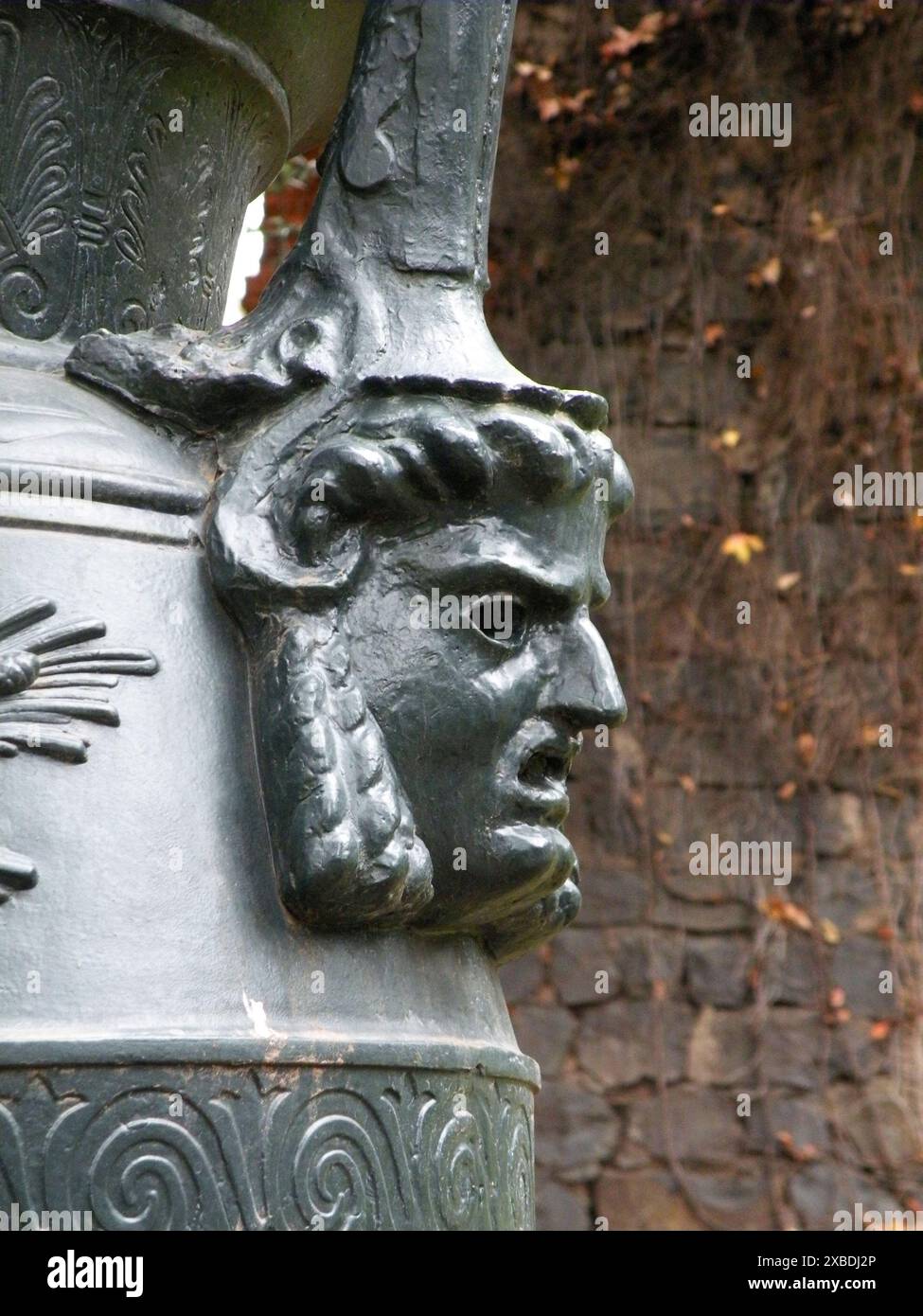 Detail with profile face in antique metal vase Stock Photo - Alamy