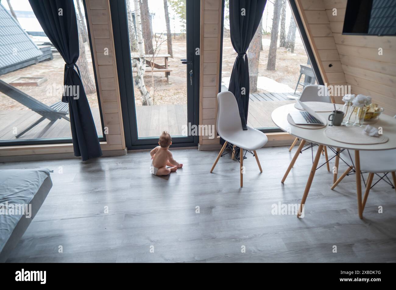 Little boy crawling on the floor by the patio window Stock Photo - Alamy
