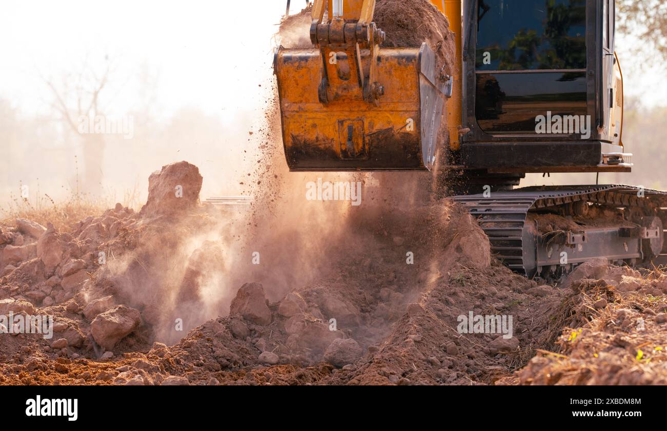 Close-up of excavator at construction site. Backhoe digging soil for ...