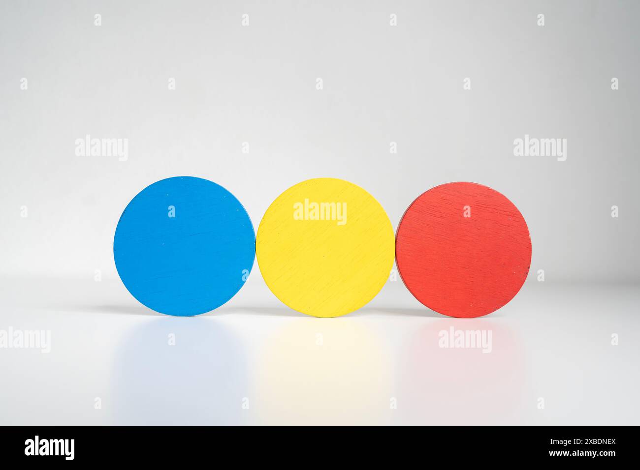 Three different colored balls are stacked on top of each other. The ...