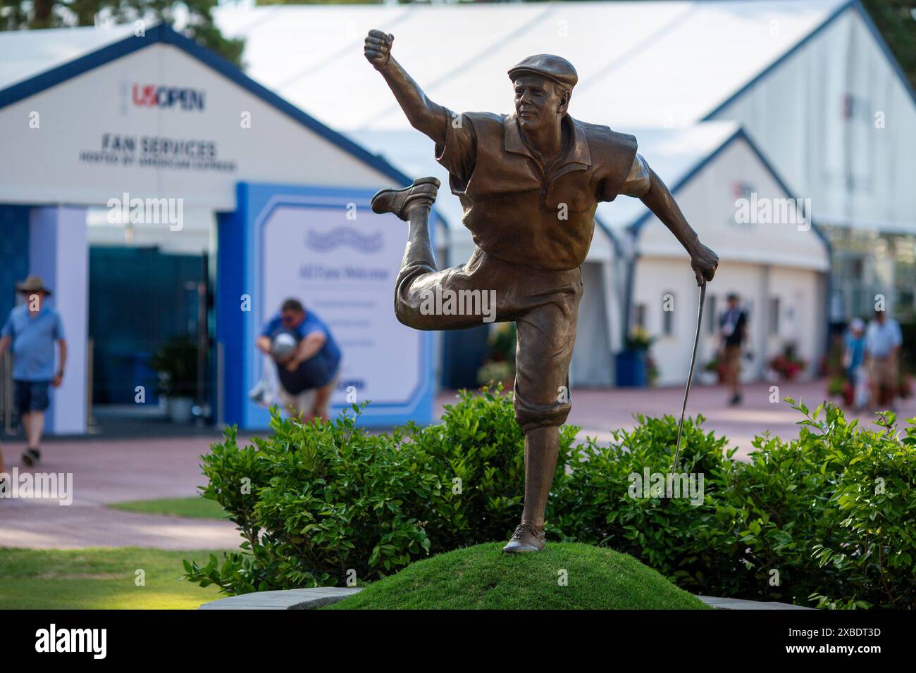 A statue of Payne Stewart stands in a fan area near the main gate ahead ...