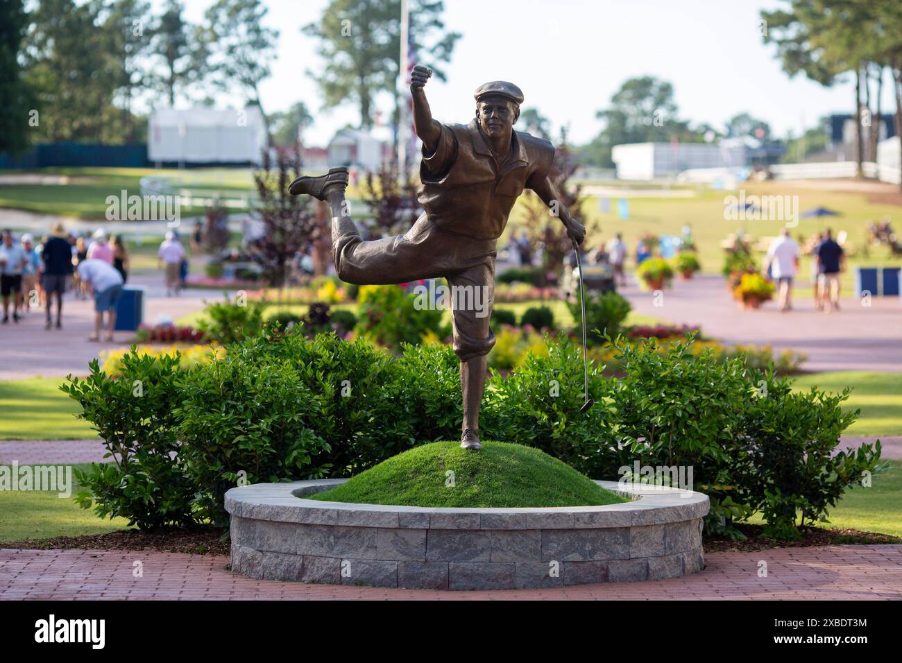 A statue of Payne Stewart stands in a fan area near the main gate ahead ...
