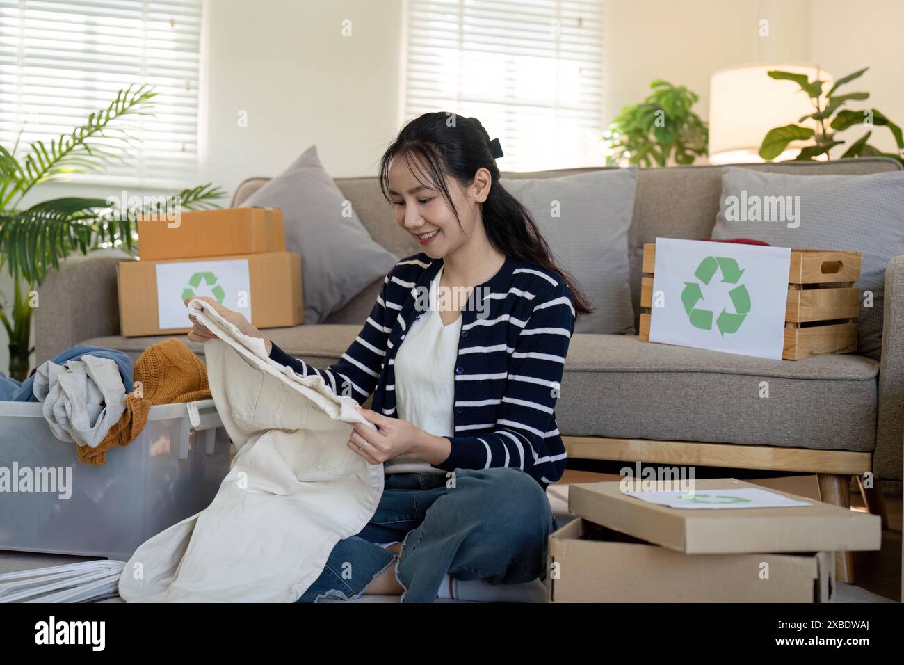 Young Woman volunteer to Recycle and Donation Clothes at Home ...