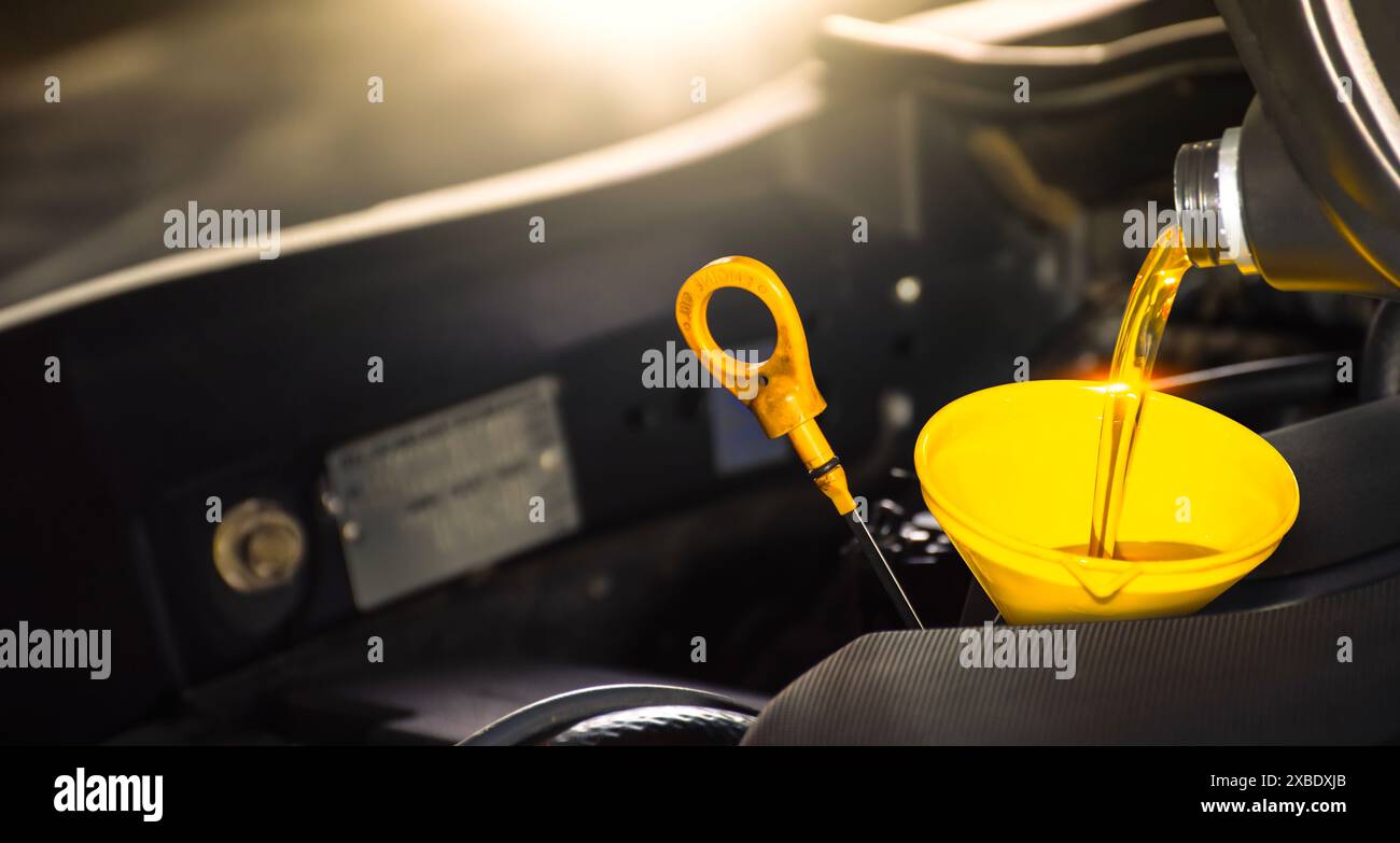 Car maintenance service , Pouring engine oil into a funnel for engine ...