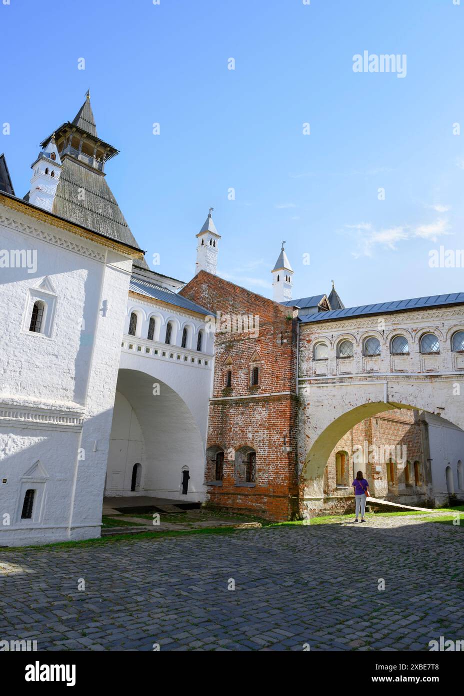 The paved courtyard of a medieval monastery with ancient buildings and ...