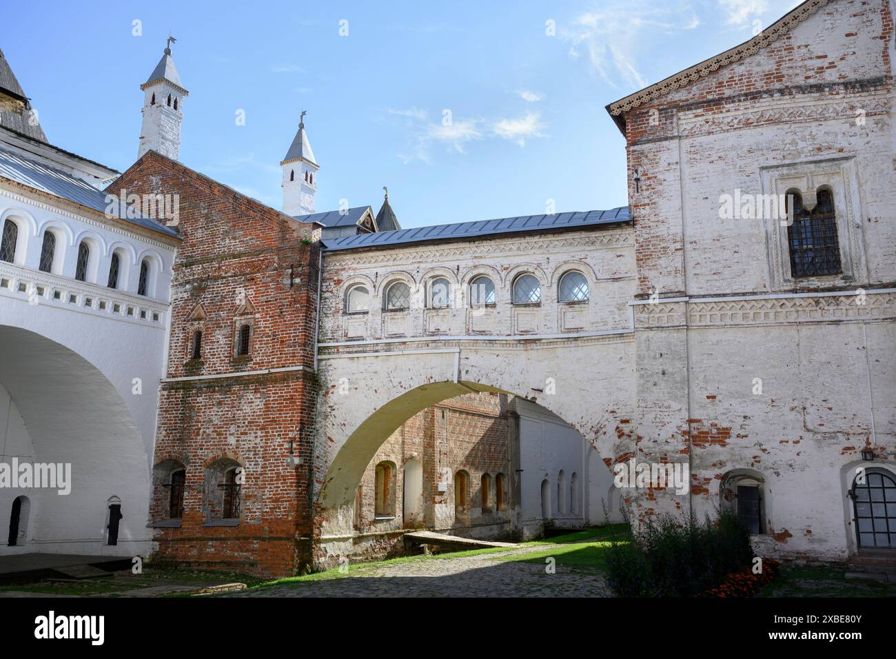The paved courtyard of a medieval monastery with ancient buildings and ...