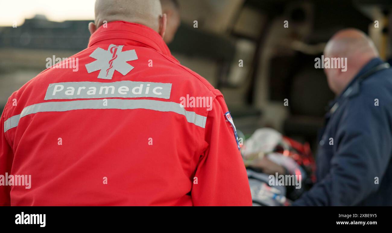 People, uniform and paramedics with emergency, service and patient with ...