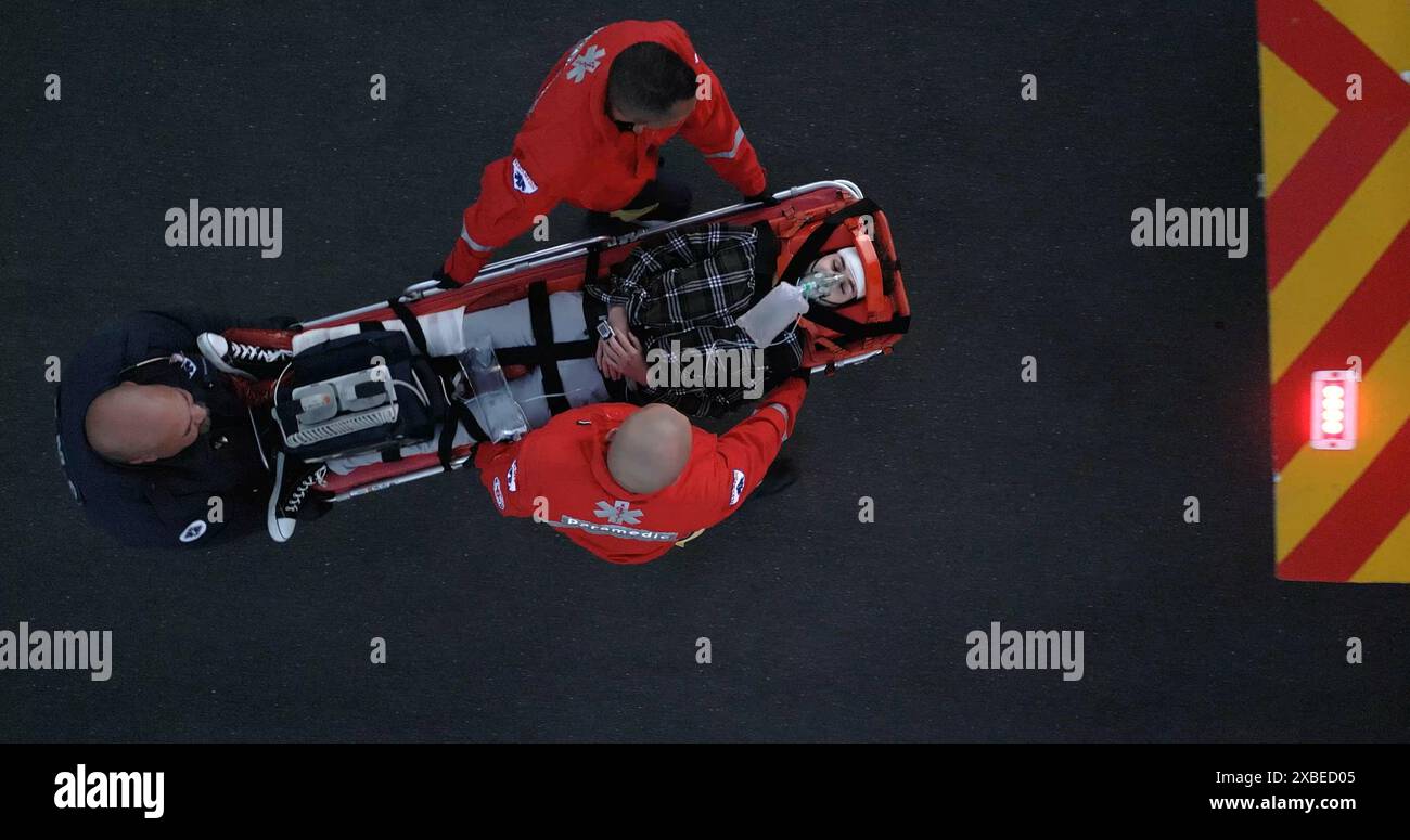 People, paramedic and above with patient in outdoor on scene for ...