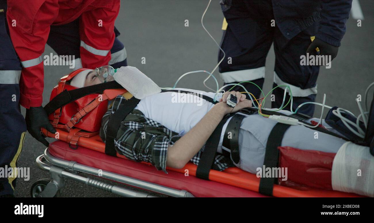 Healthcare, paramedic and help patient in road on scene for emergency ...