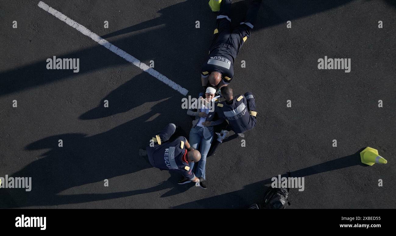 EMS, team and paramedic with patient, outdoor and accident, injury and ...