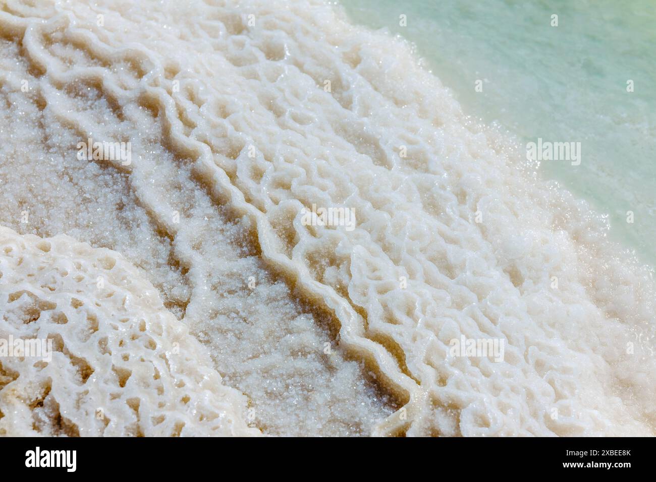 Natural salt deposits on the beach shoreline offer stunning beauty and ...