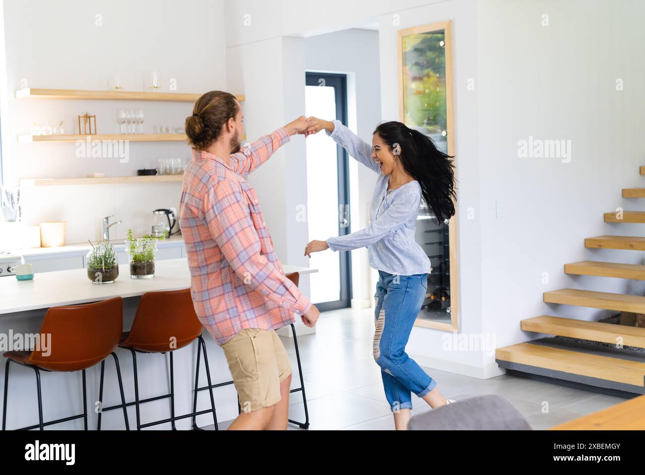 Young diverse couple are dancing joyfully together Stock Photo - Alamy