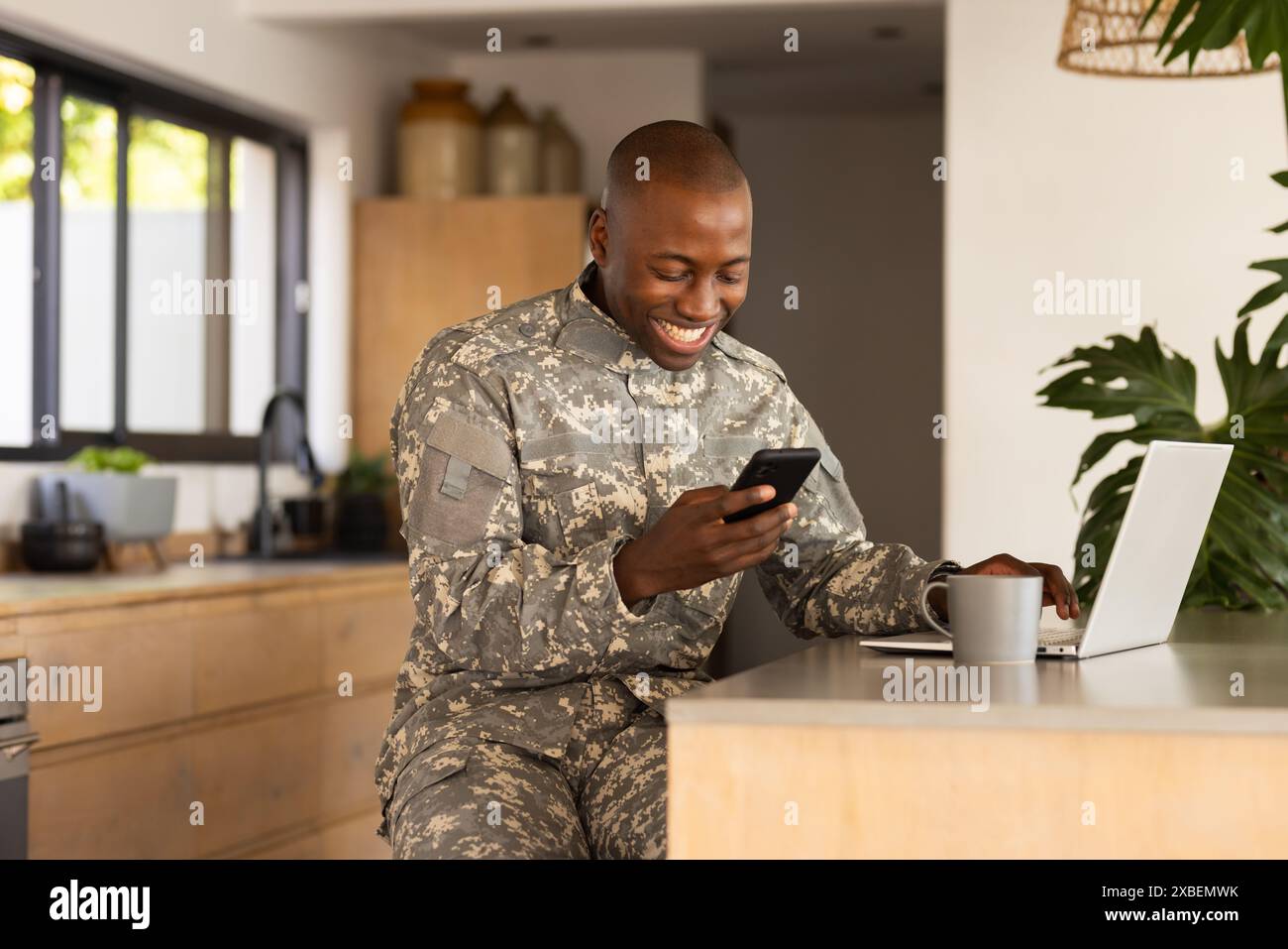 Young African American soldier in military uniform smiling at ...