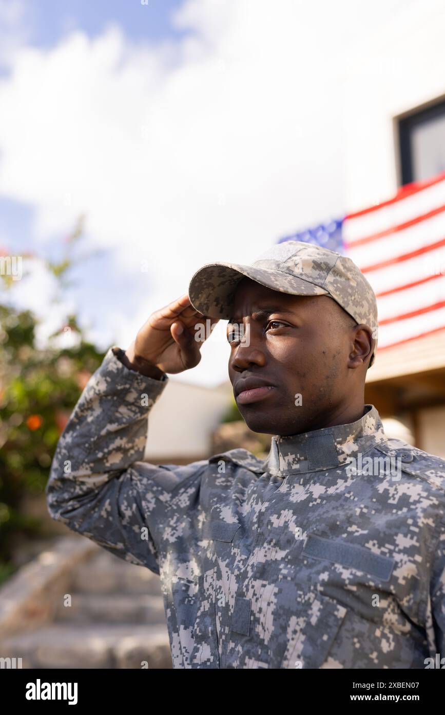 Young African American soldier in military uniform saluting with pride ...