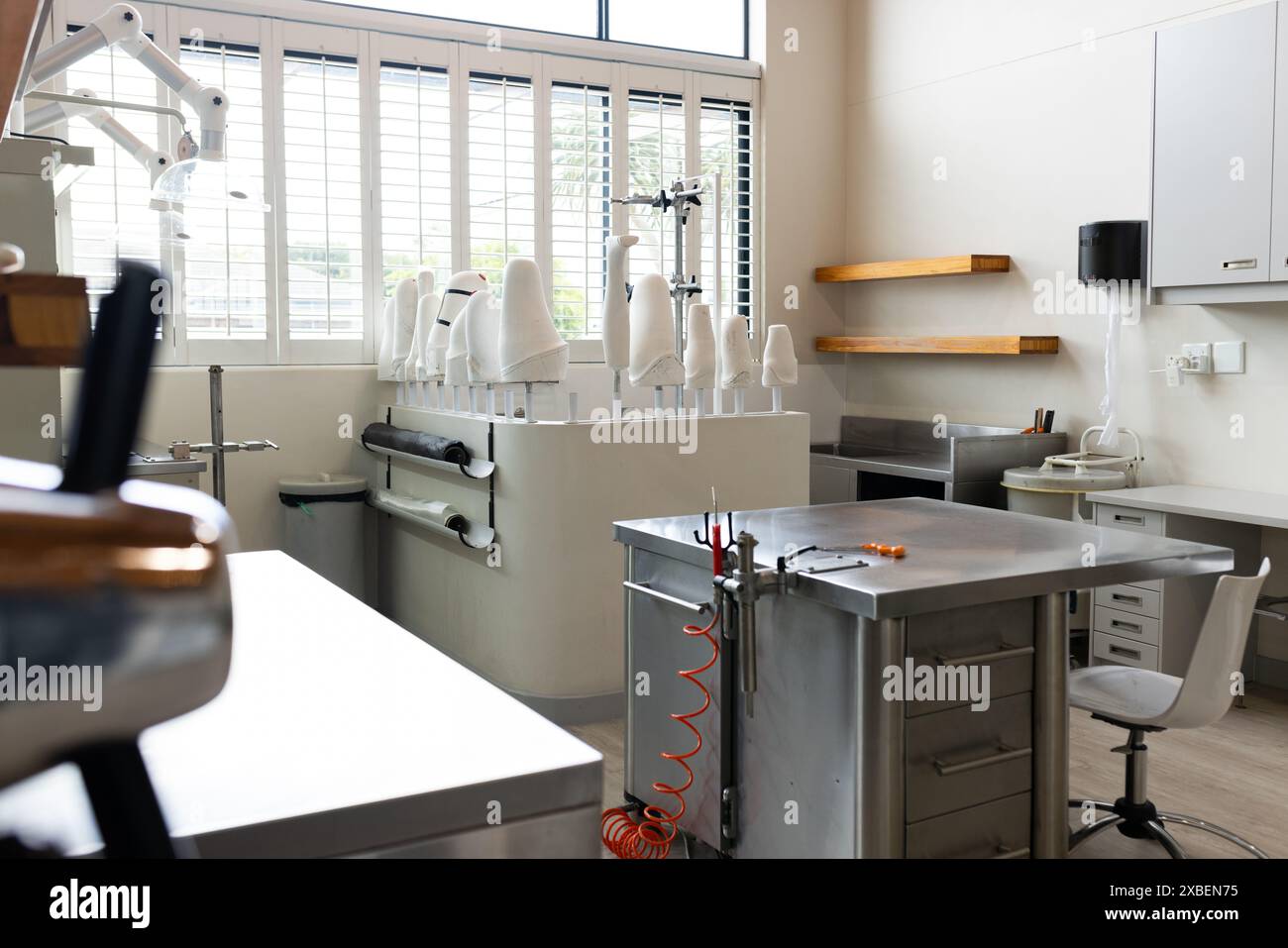 Modern prosthetic lab with various prosthetic limbs displayed on ...