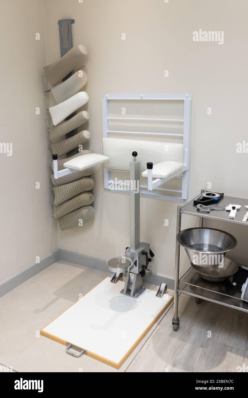 Prosthetic lab equipment is neatly organized on wall and metal cart ...