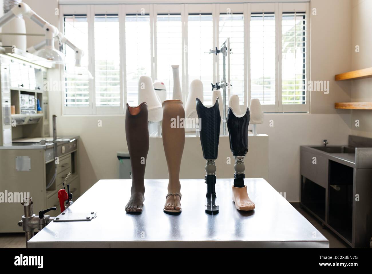 A set of prosthetic legs with various skin tones displayed on table in ...