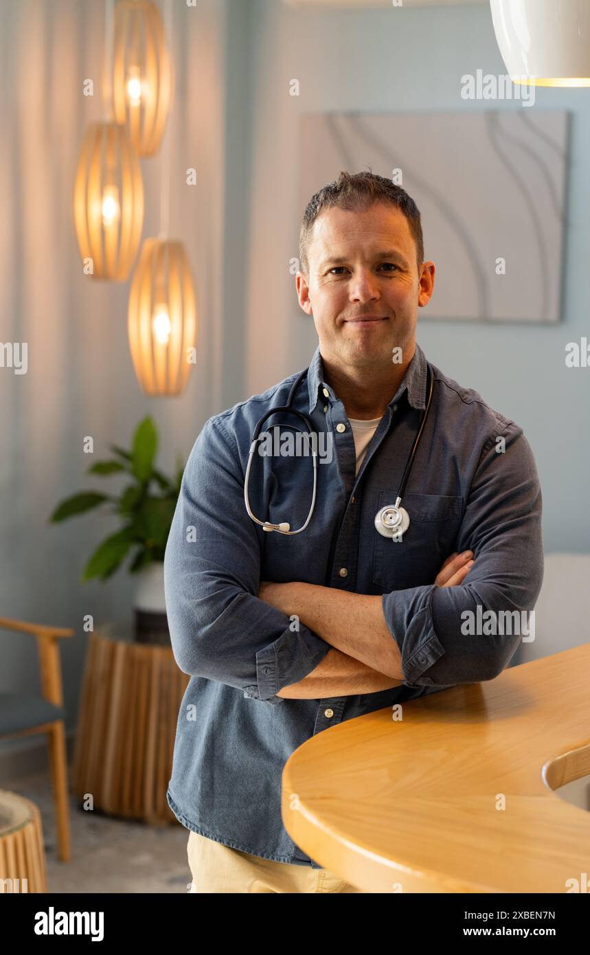 Middle-aged Caucasian male doctor in reception with a stethoscope ...